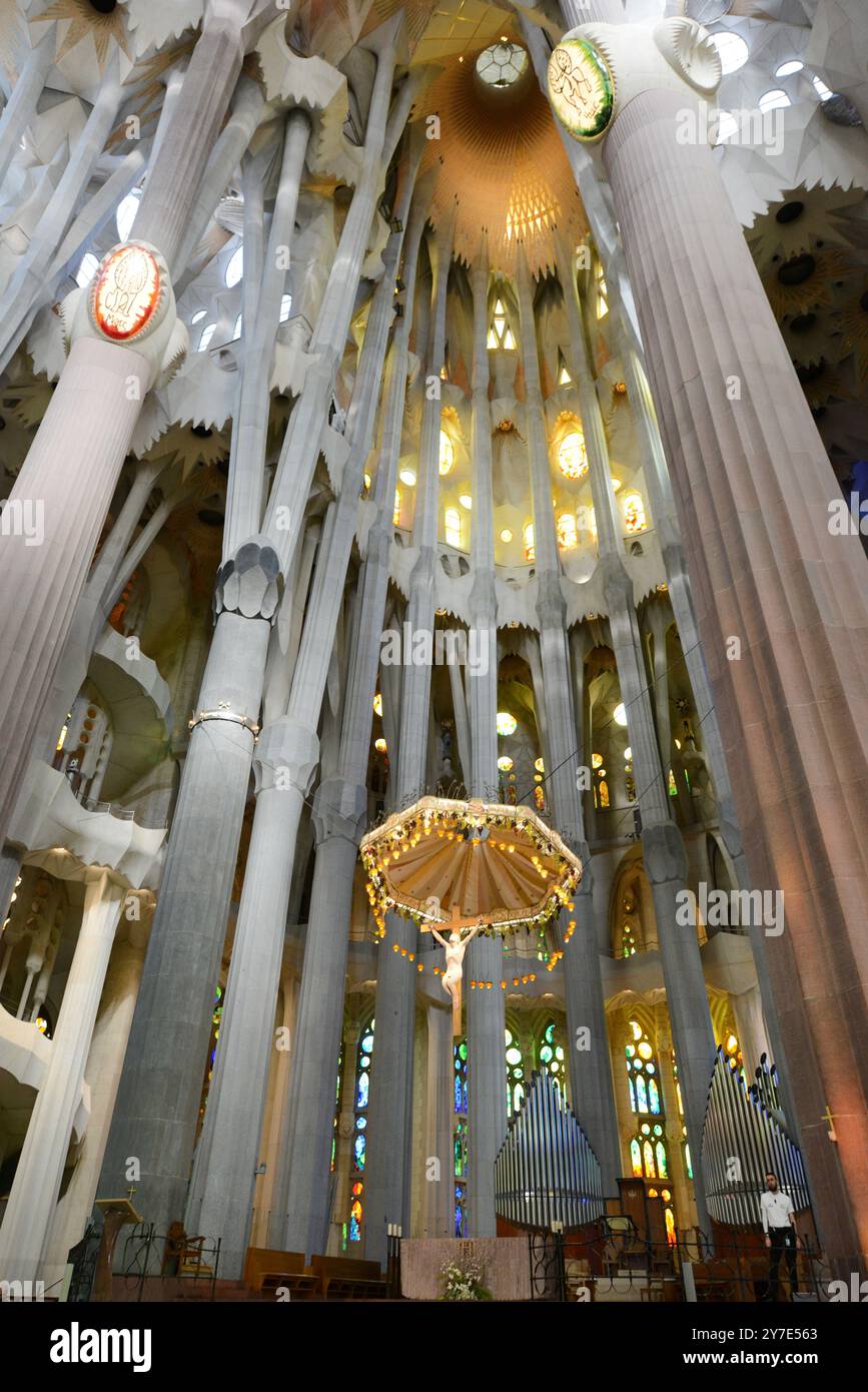 Crucified Jesus Christ statue above altar in the Sagrada Familia basilica in Barcelona ...