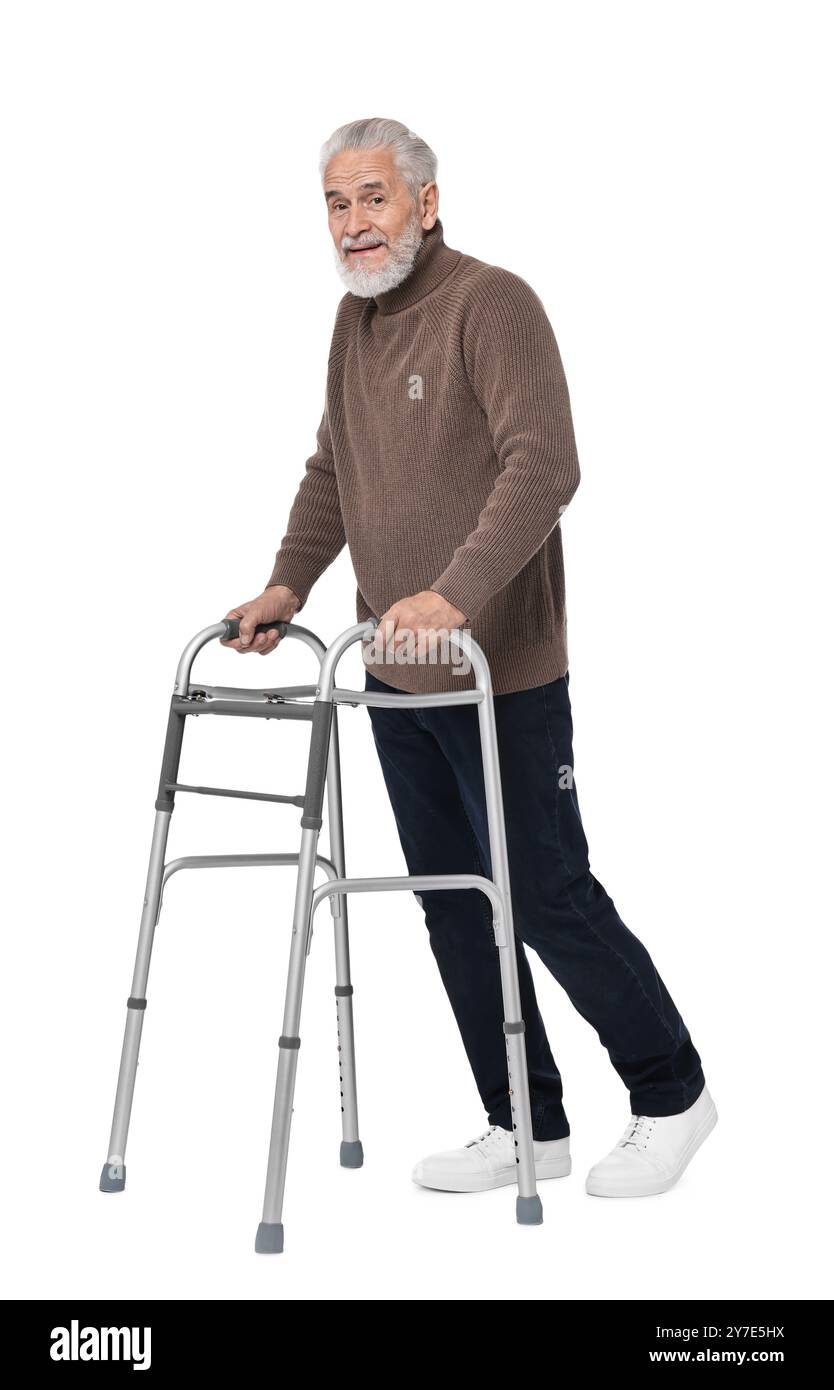 Senior man using walking frame on white background Stock Photo - Alamy