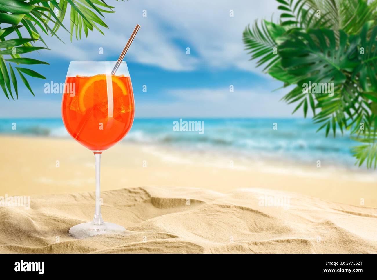 Summer beach with Aperol Spritz delicious cocktail, tropical leaves and ...