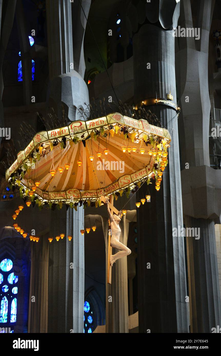 Crucified Jesus Christ statue above altar in the Sagrada Familia basilica in Barcelona ...