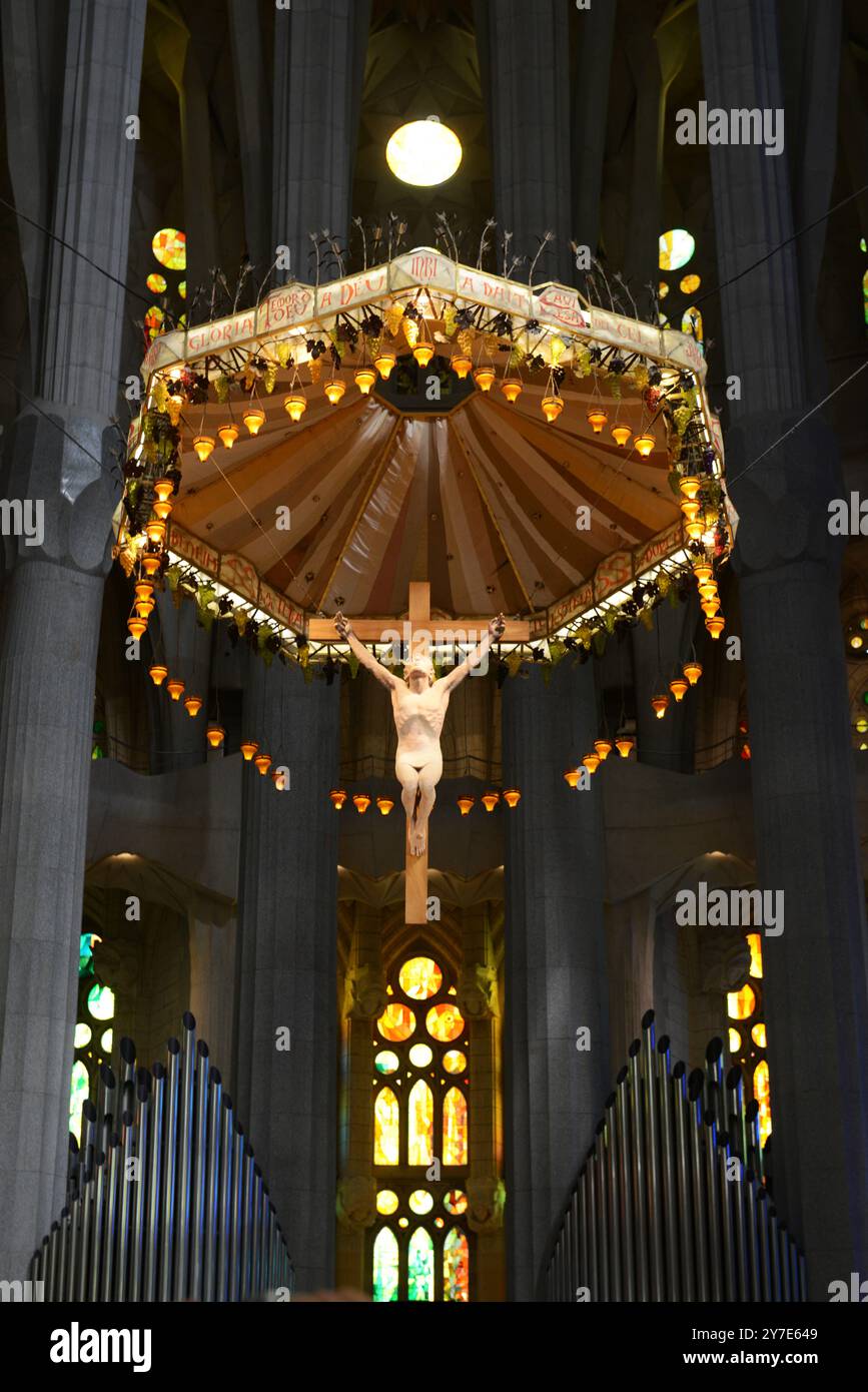 Crucified Jesus Christ statue above altar in the Sagrada Familia basilica in Barcelona ...