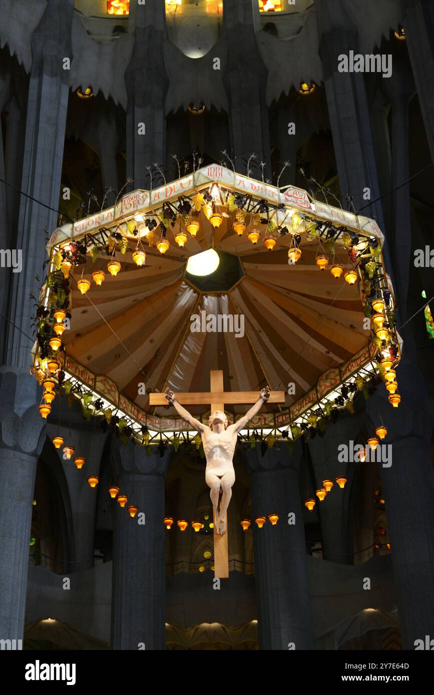 Crucified Jesus Christ statue above altar in the Sagrada Familia basilica in Barcelona ...