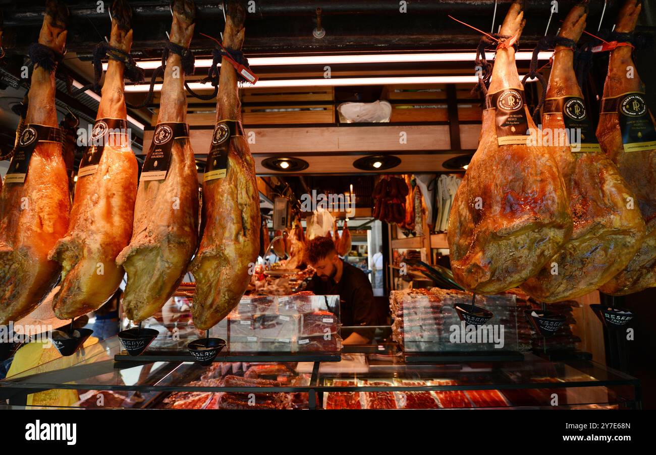 Spanish ham displayed by a shop at the Mercat de la Boqueria in ...