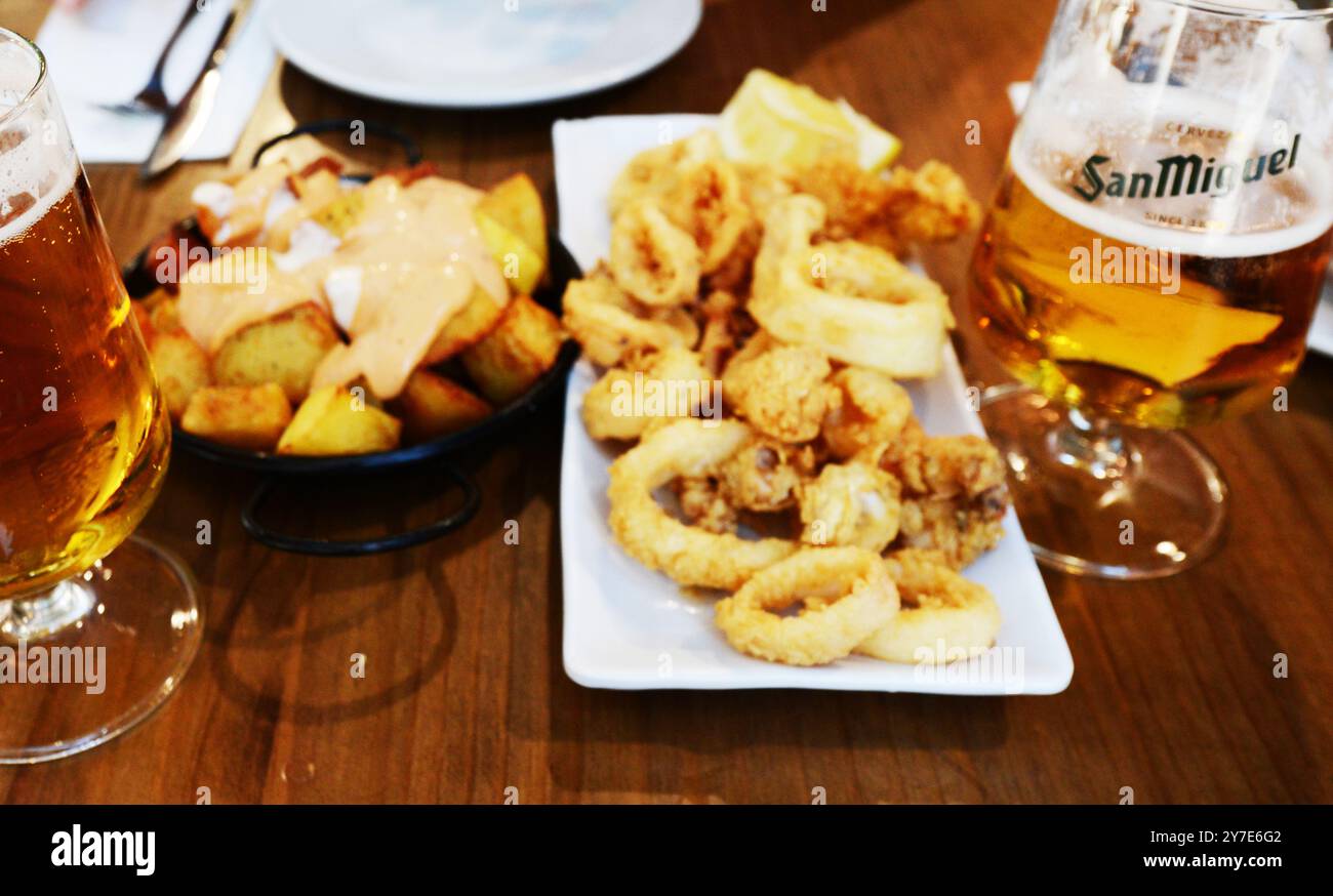 Fried calamari and Patatas Bravas tapas. Bar Central Tapas bar at the ...