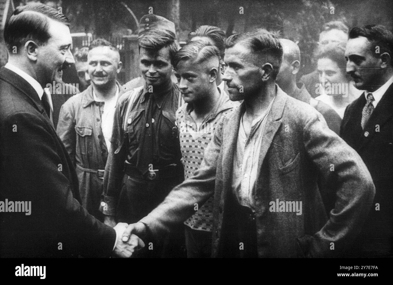 Adolf Hitler shaking hands with young men during a public meeting in ...