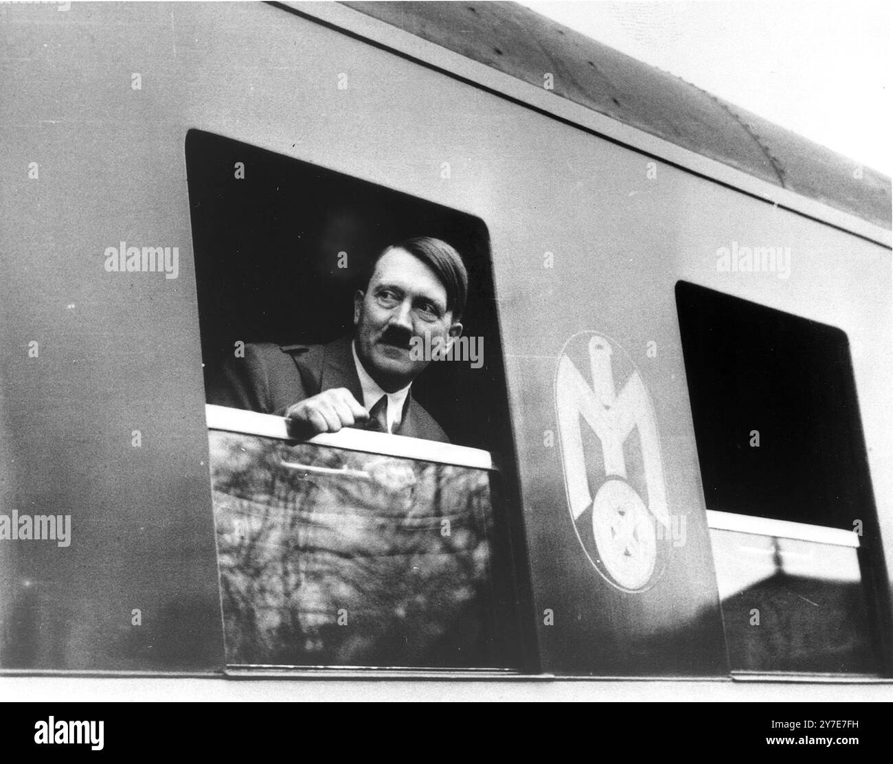 Adolf Hitler looks out the window of a train. The photo is dated 25th ...