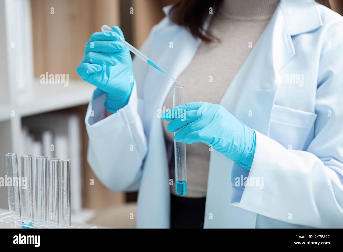 Scientist Conducting Experiment in Modern Laboratory with Test Tubes ...