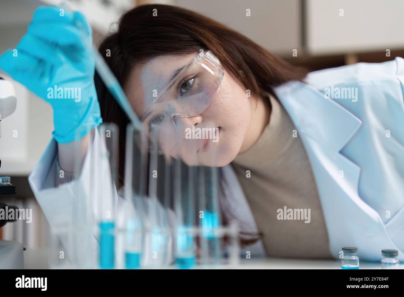 Scientist Conducting Experiment in Modern Laboratory with Test Tubes ...