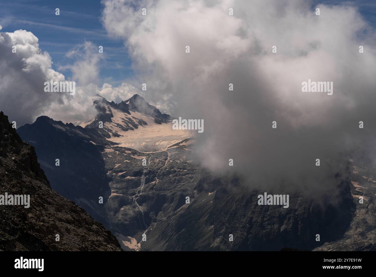 Cloud-Covered Mountain Peaks with Snow and Glacial Terrain Stock Photo - Alamy