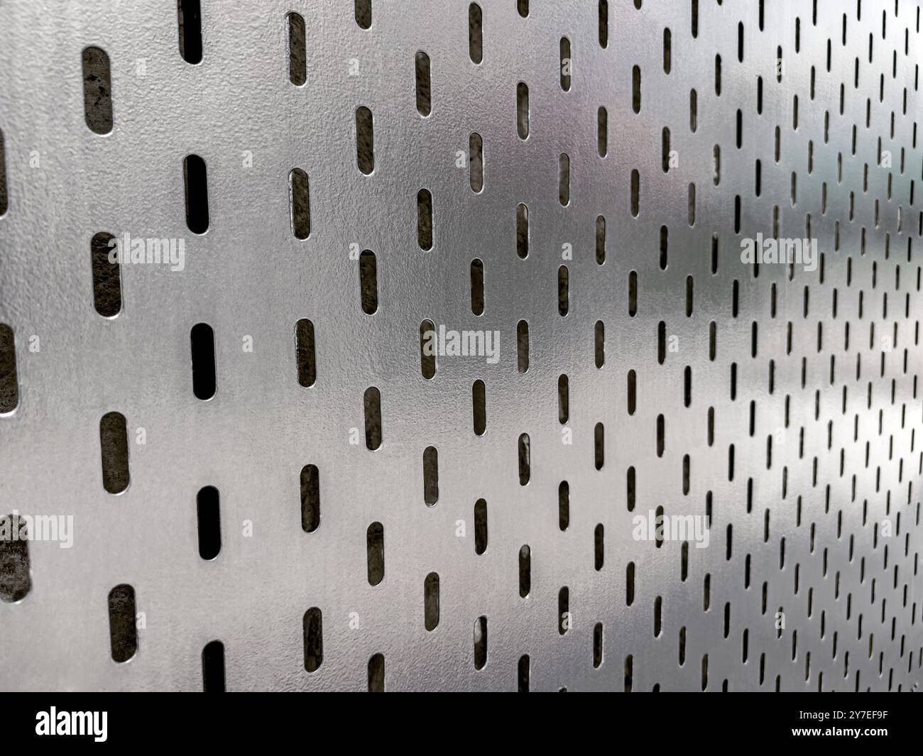 metallic mesh background with oblong holes. perforated shiny metal ...