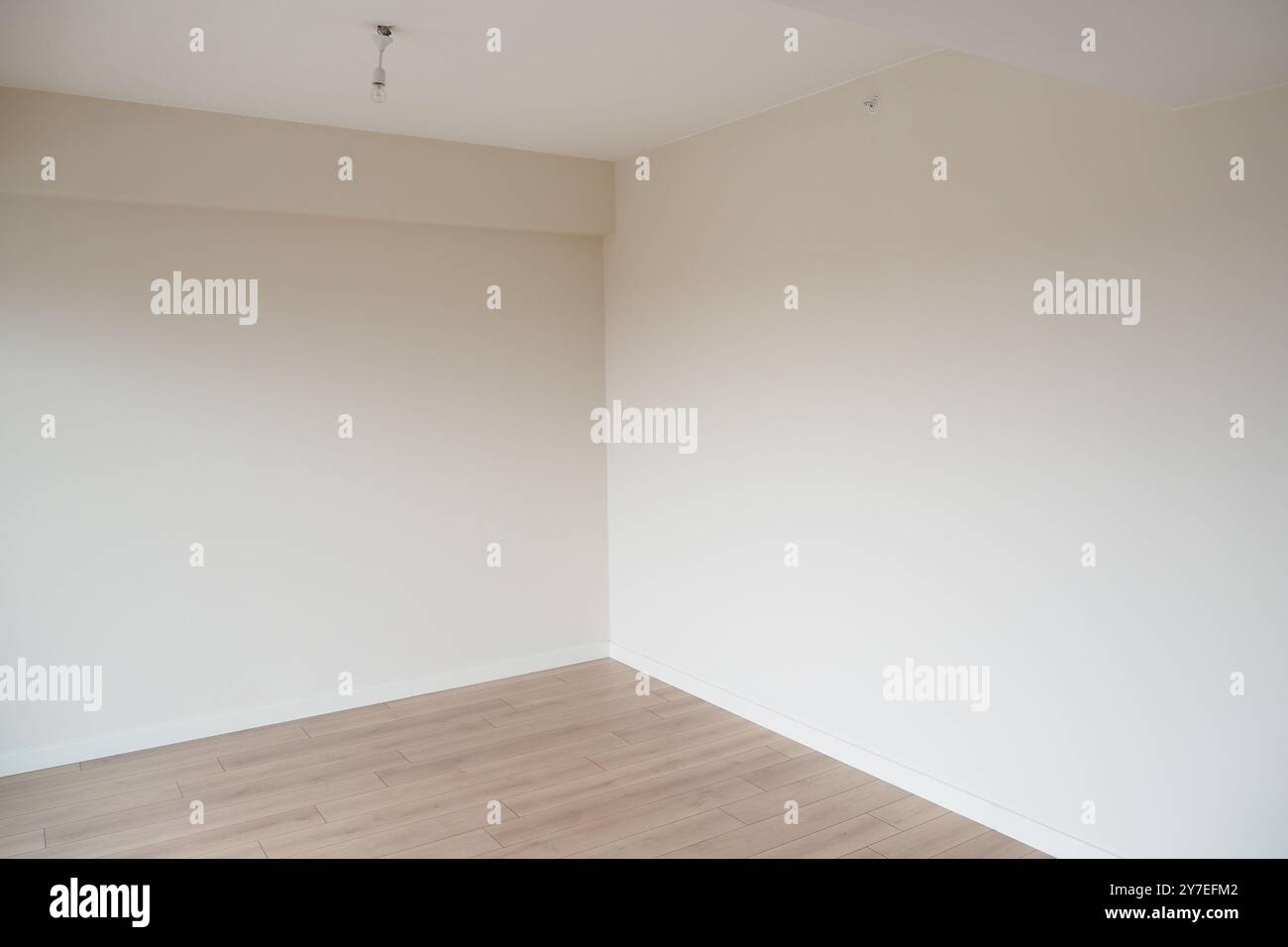 An empty room featuring neutralcolored walls along with elegant wooden ...