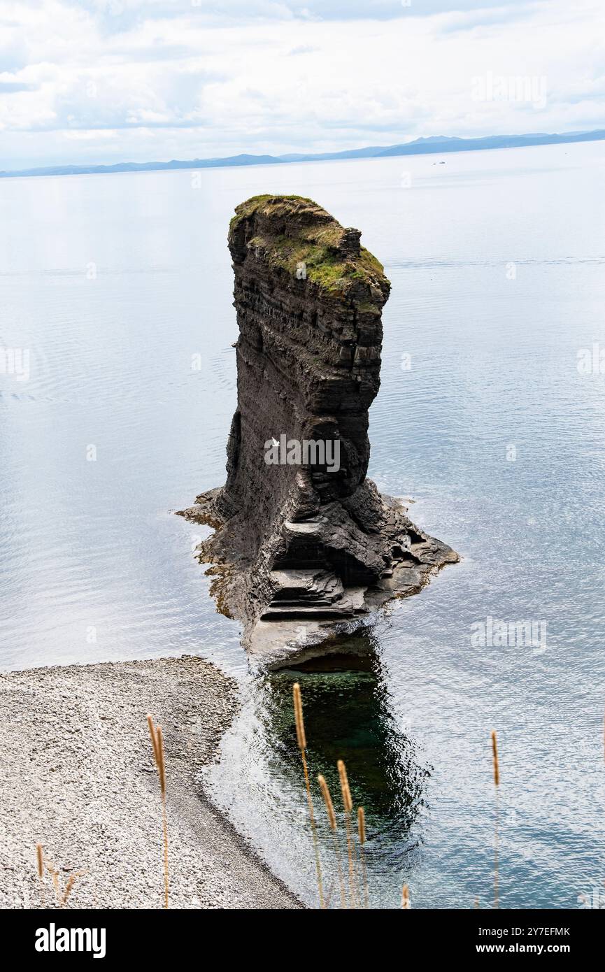 Skinny sea stack on the beach near the Bell on Bell Island ...