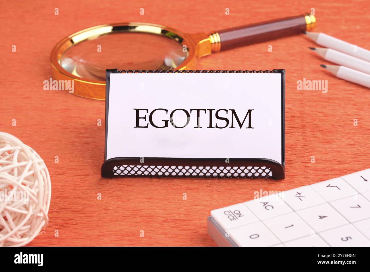 Concept image. the word EGOTISM on a white business card, front view ...