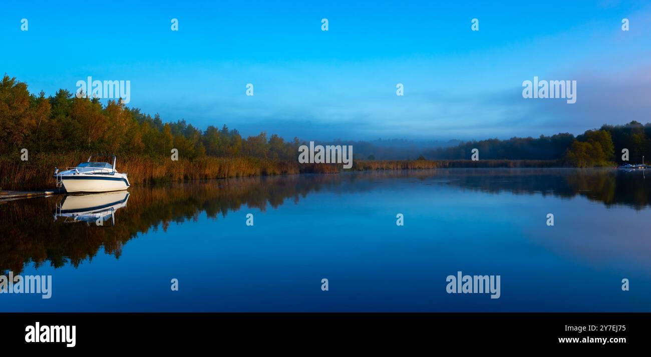 Calm water early morning with nice reflection Stock Photo - Alamy