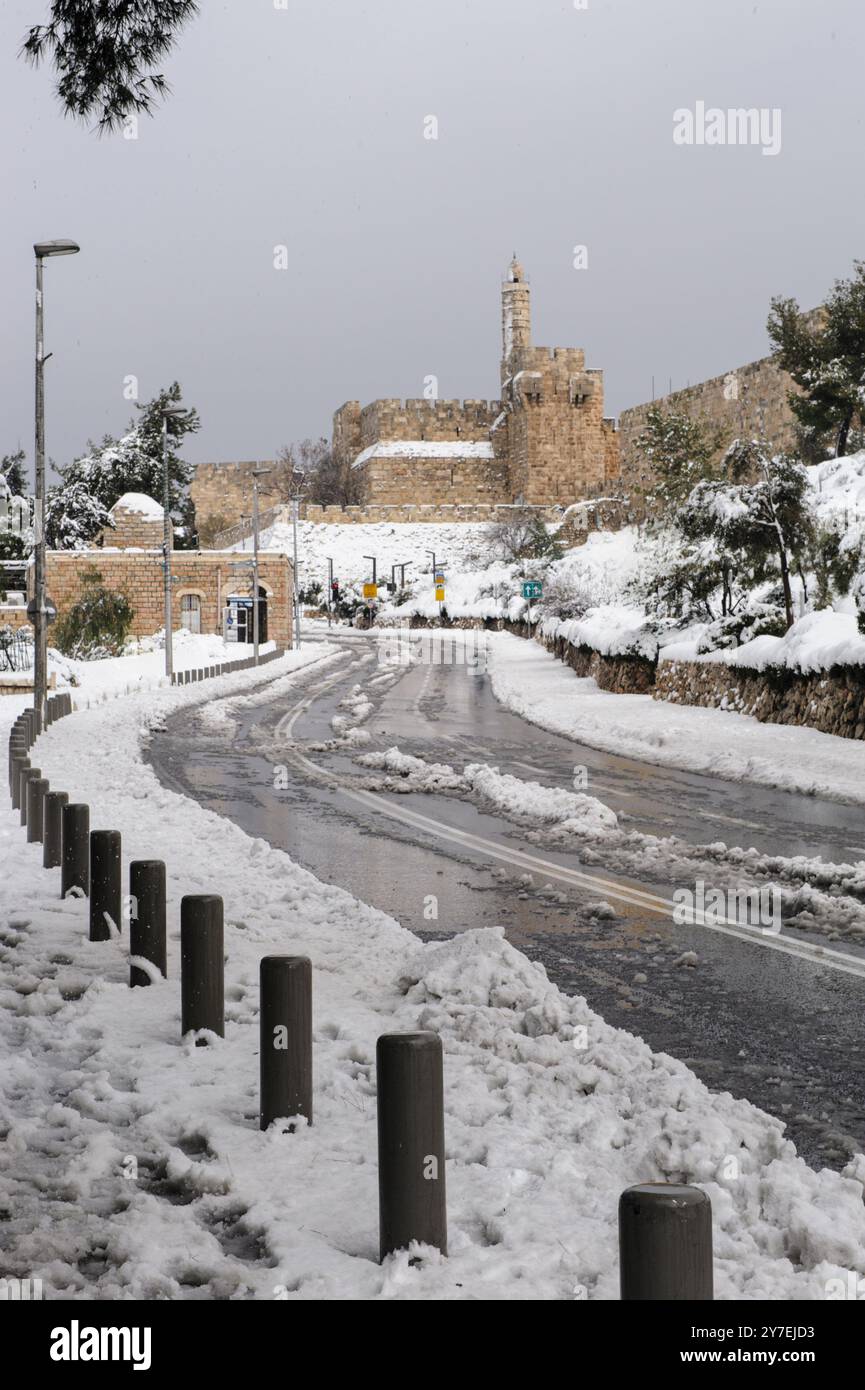 Following a light winter storm in Jerusalem, snow collects on the road ...