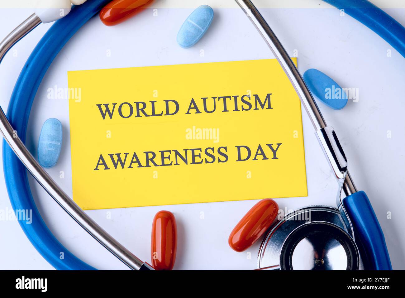 WORLD AUTISM AWARENESS DAY written on the yellow card. Concept photo ...