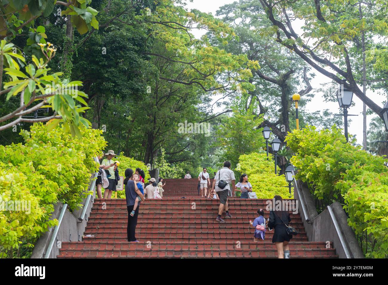 People visitors tourists are actively climbing long flight of stairs ...