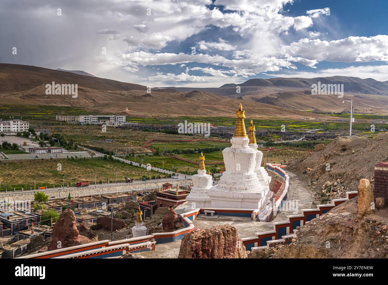 White stupa with golden top and part of the the buddhist Sakya ...
