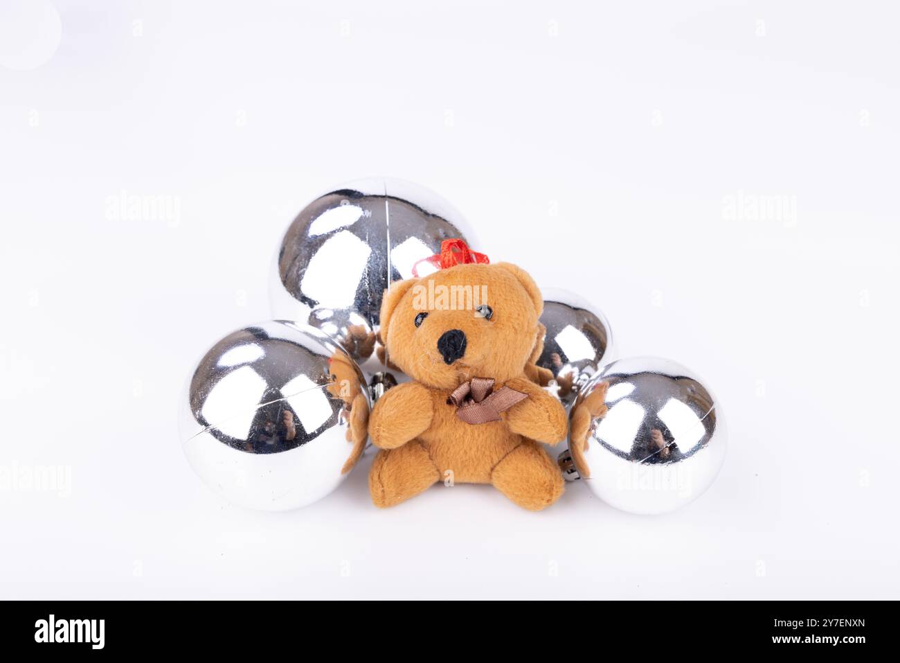 This adorable teddy bear is playfully arranged with shimmering silver ...