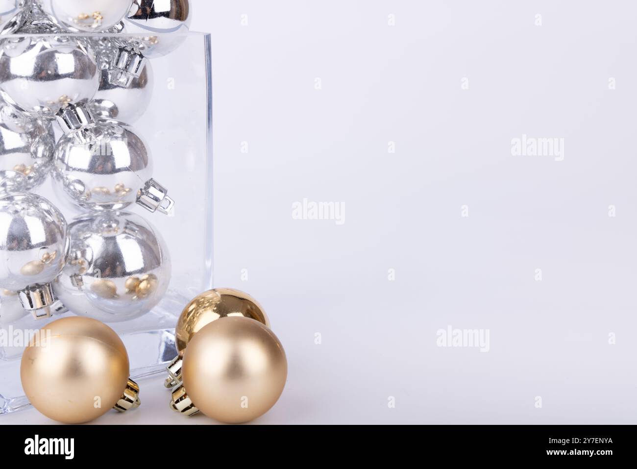 A chic arrangement featuring a crystal vase brimming with silver balls ...