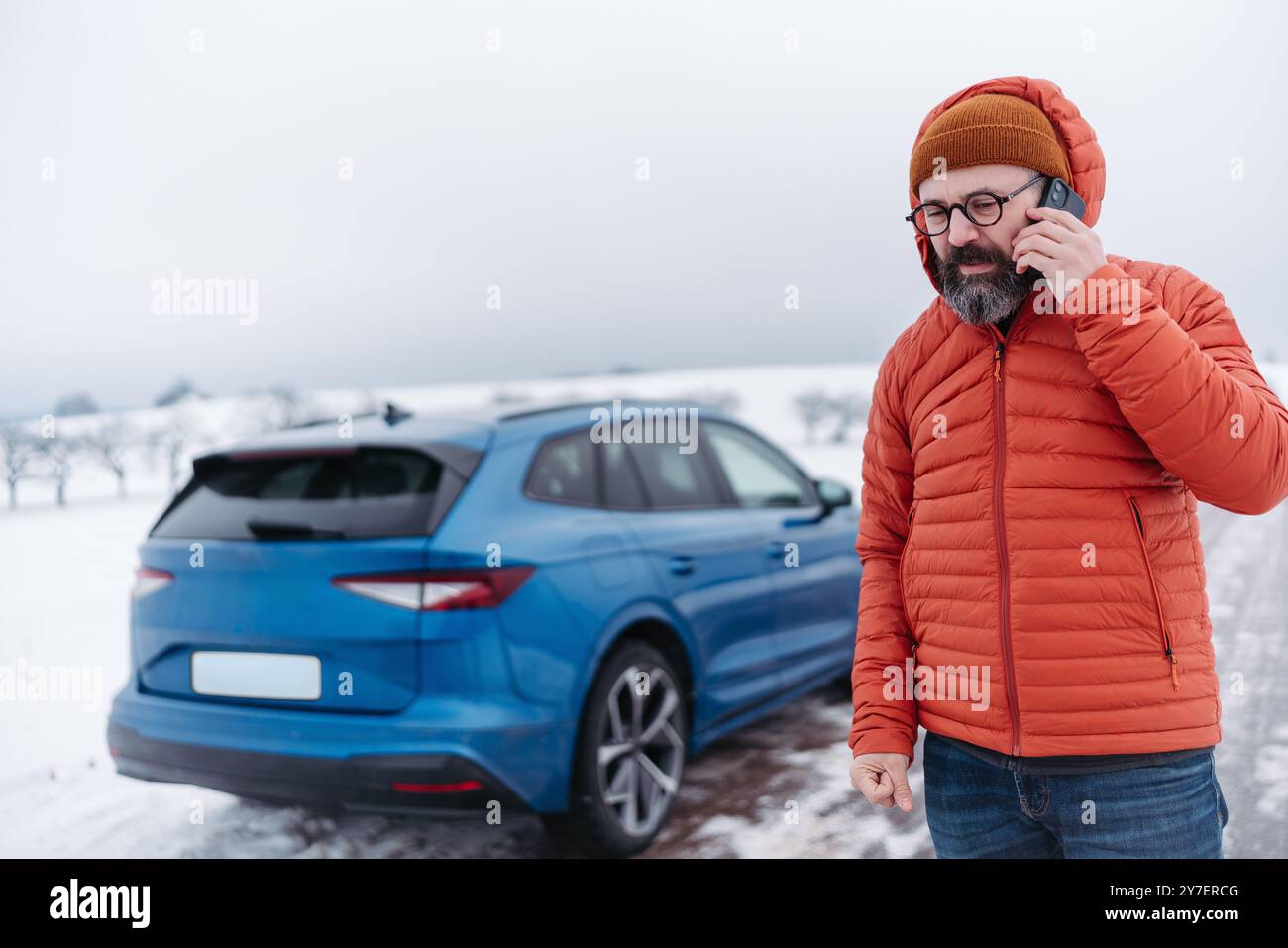 Angry man standing by electric car, battery run out of power before ...