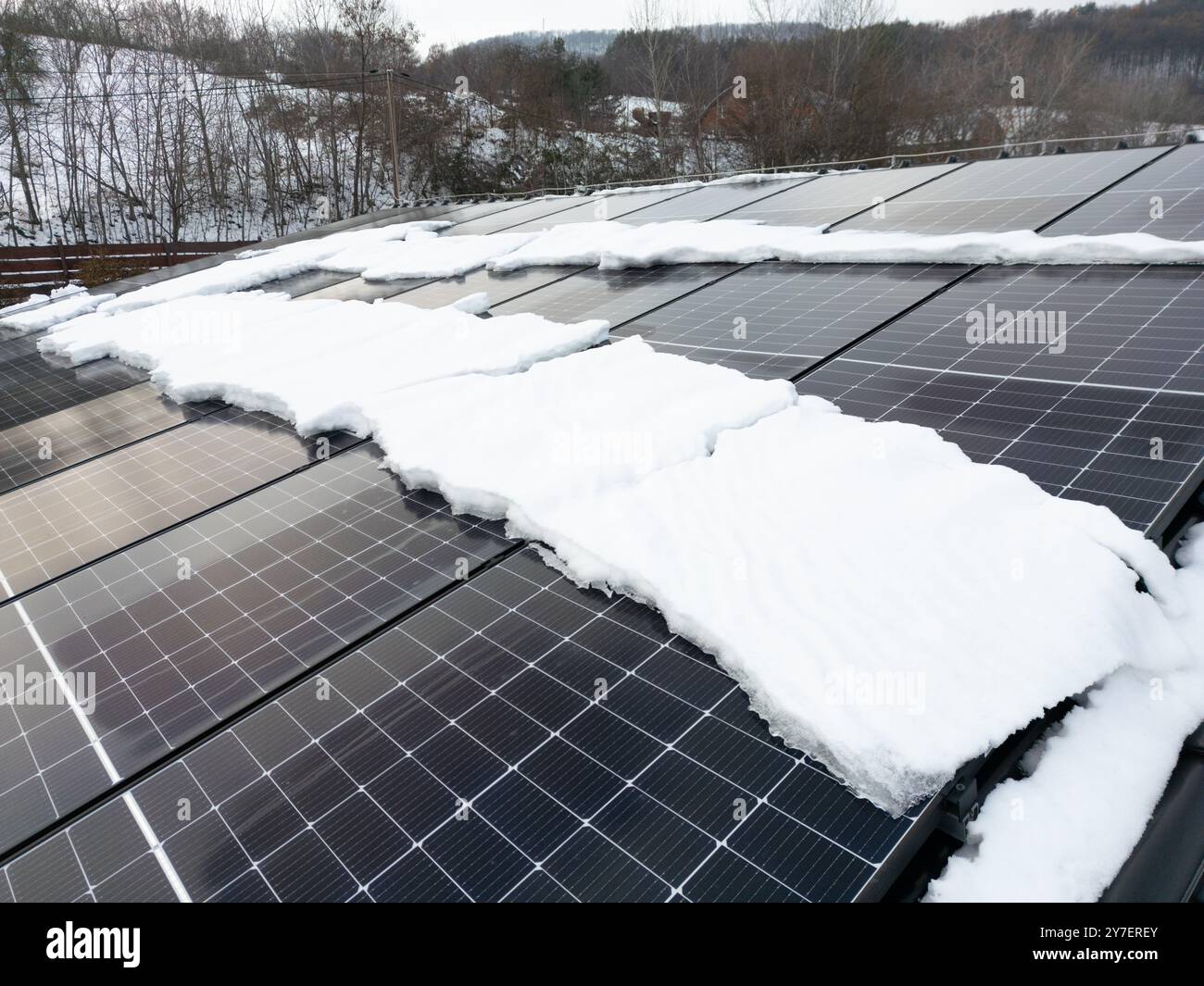 Roof solar panels with snow on top of them. Solar energy in winter ...