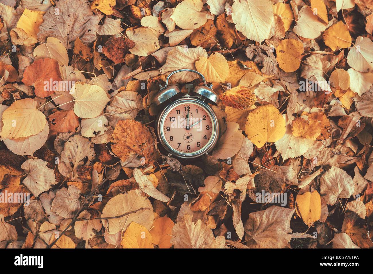 Daylight saving time concept, old analog alarm clock set to two o'clock ...