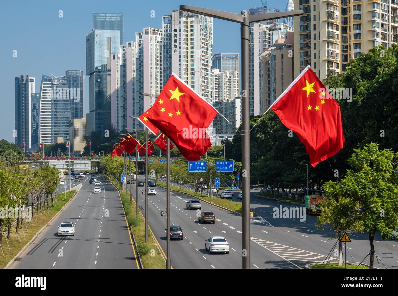National flags are hung up along the street in Shenzhen City, south ...