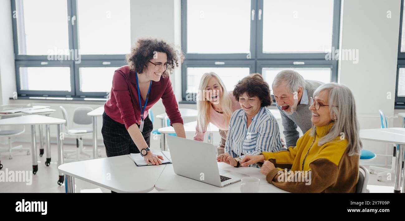 Teacher explaining senior students how to start their own business ...