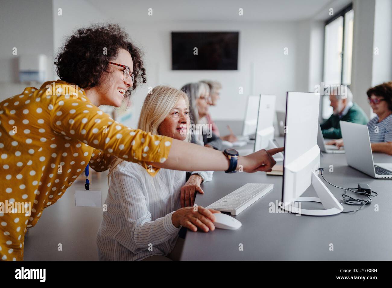Portrait of female senior student learning how to work with digital ...