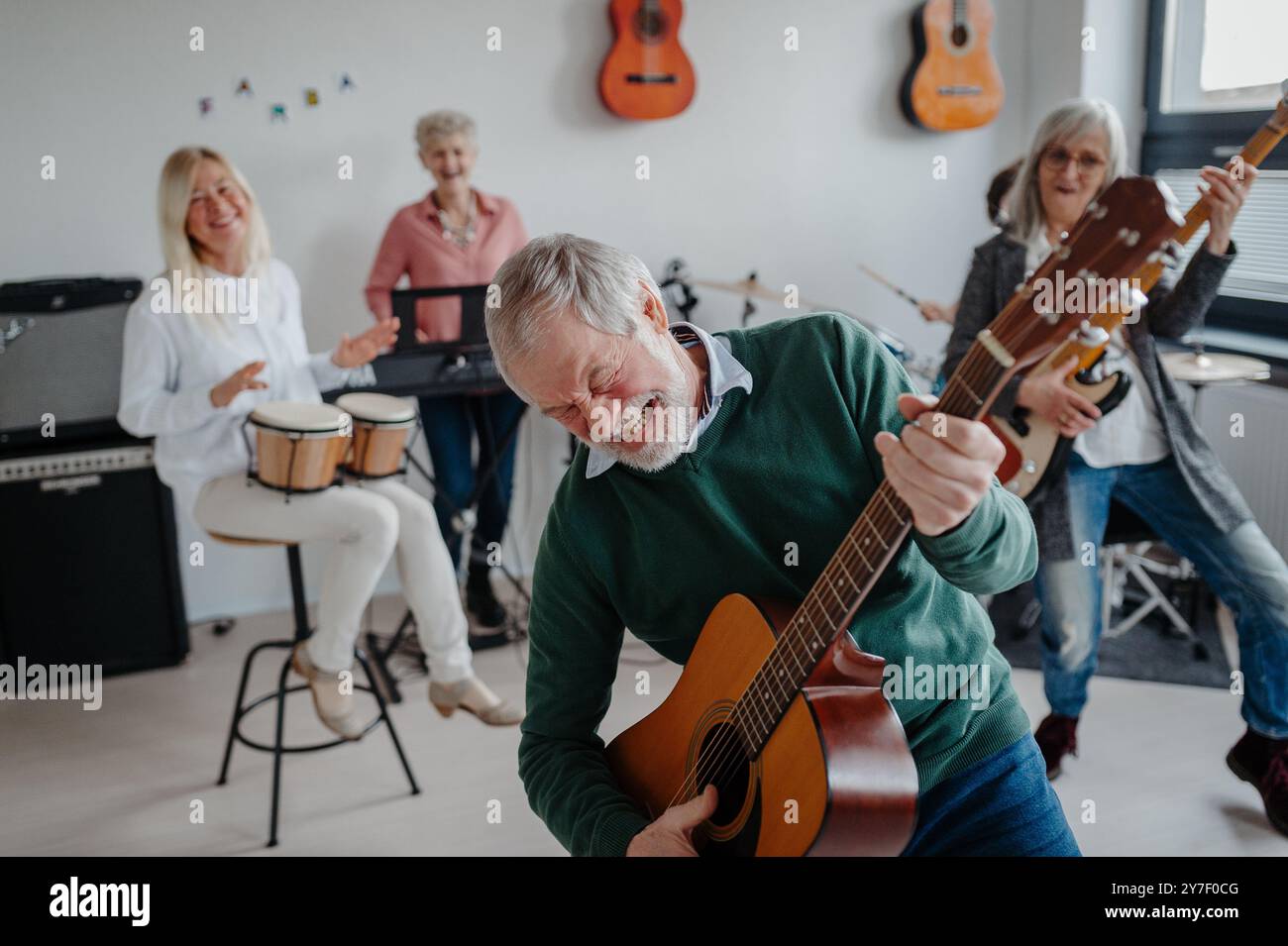 Group of seniors meeting to play musical instruments together in band ...