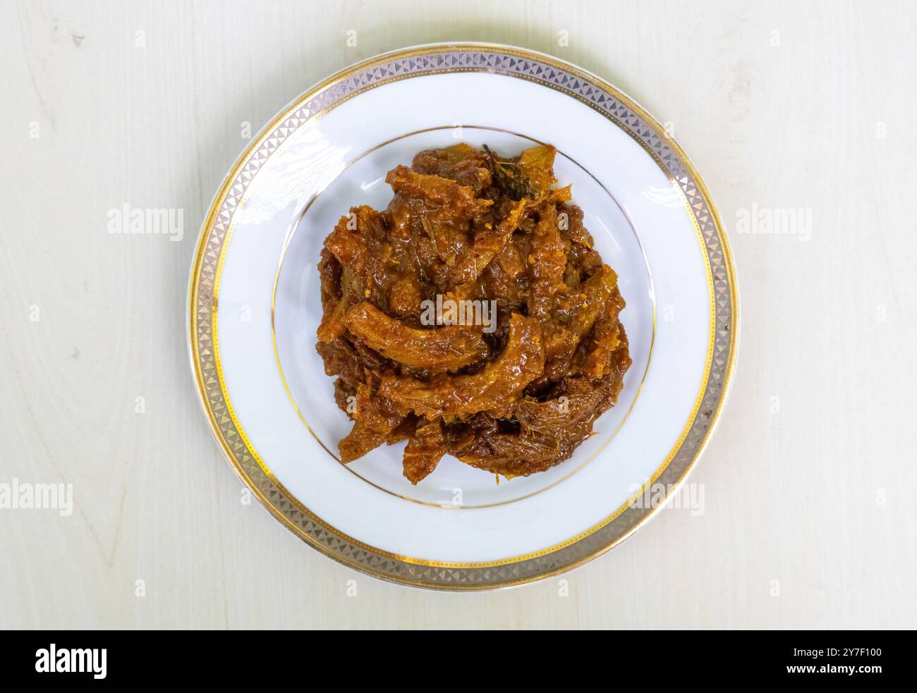Homemade elephant apple pickle (chalta achar) served on a white plate ...