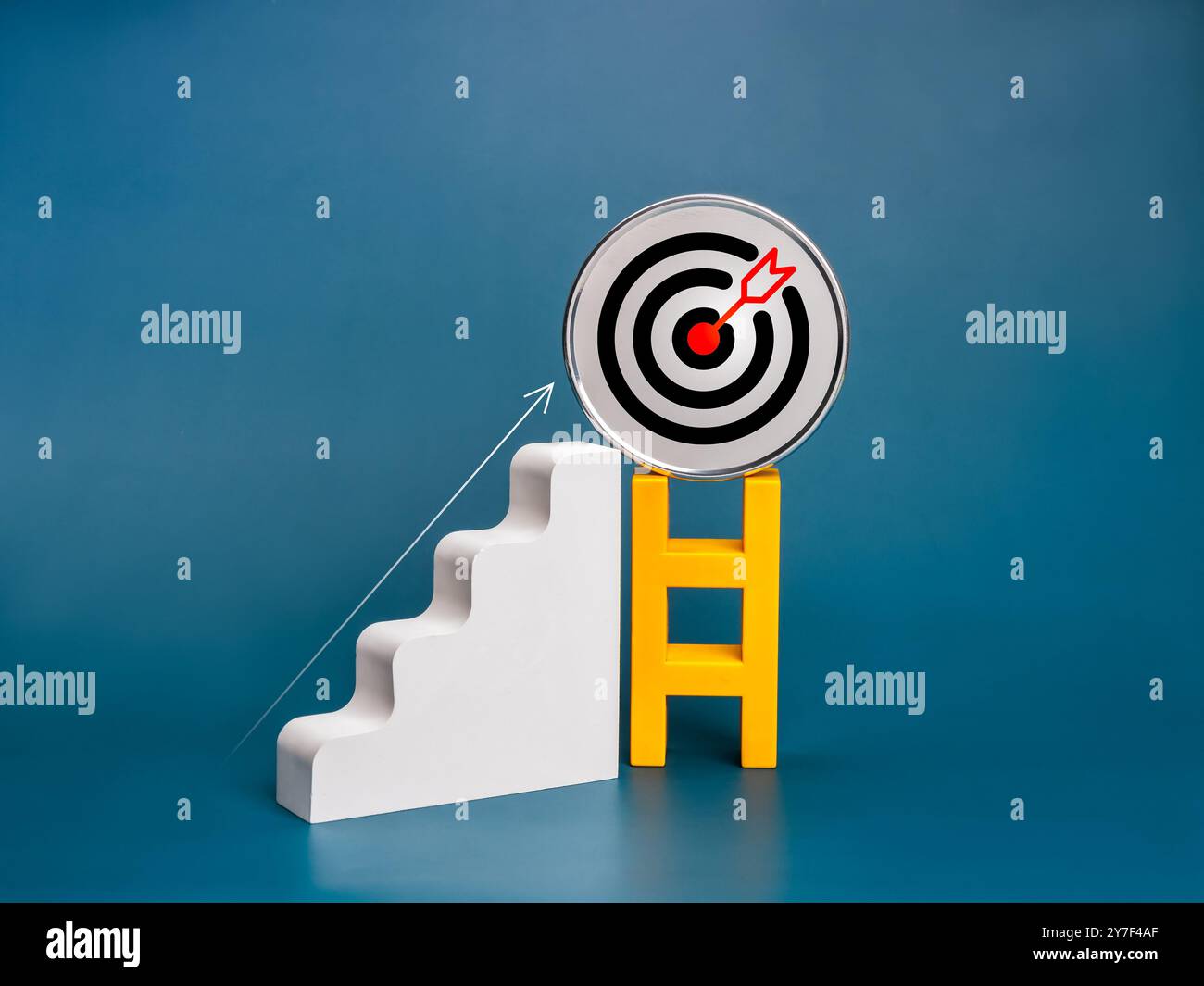 Round metal target icon on top of minimal yellow ladder near arrow and ...