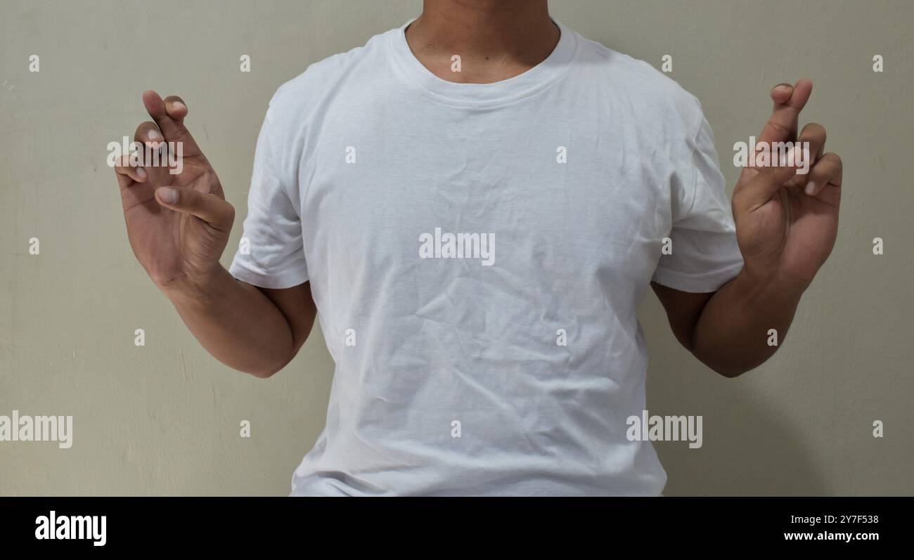 Young hopeful man crossing hi-res stock photography and images - Alamy