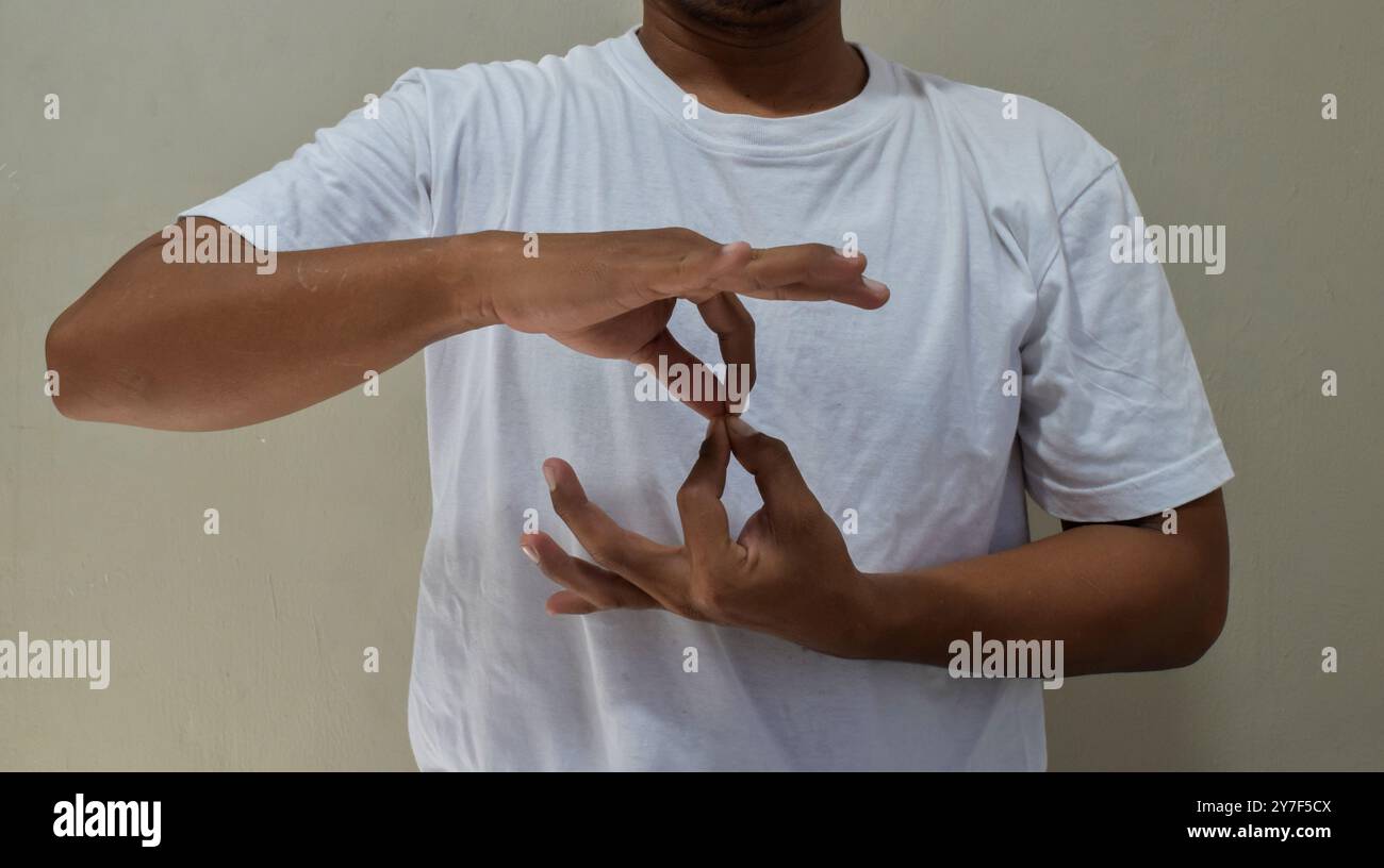 Young man learning and communicating in american sign language Stock ...