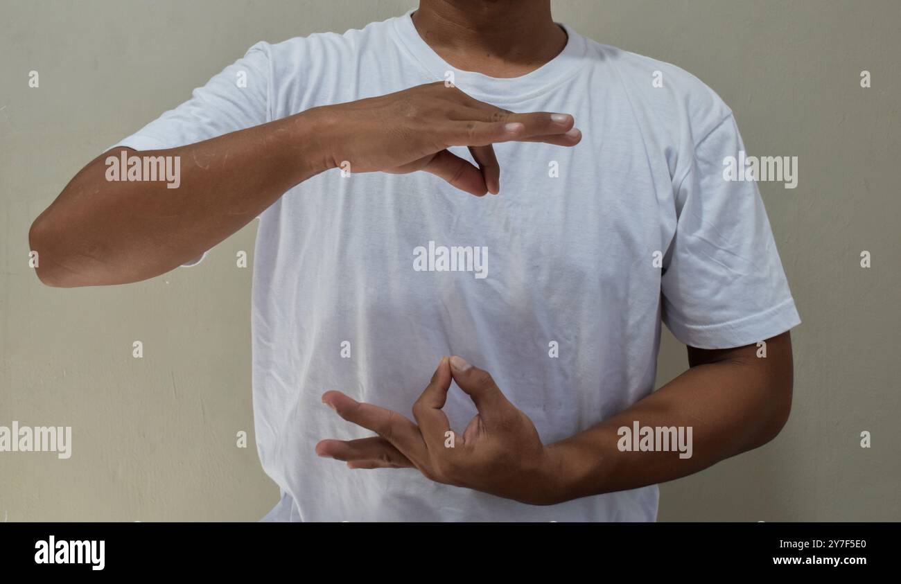 Young man learning and communicating in american sign language Stock ...