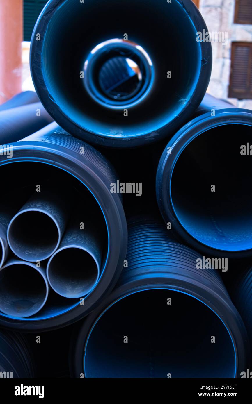PVC pipes stacked on the street creating abstract figures Stock Photo ...