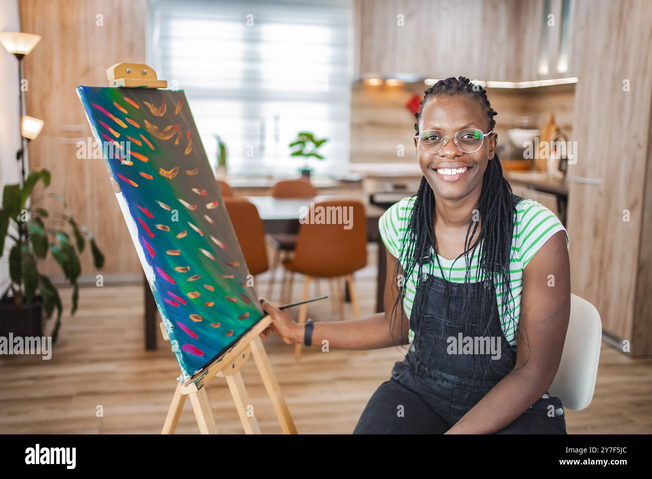 Artist creating a vibrant masterpiece in a studio Stock Photo - Alamy
