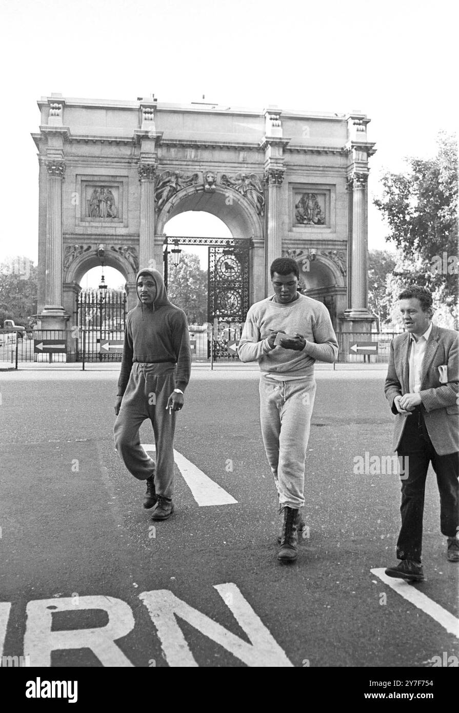 Accompanied by his brother Rahaman Ali (background), Cassius Clay, the ...