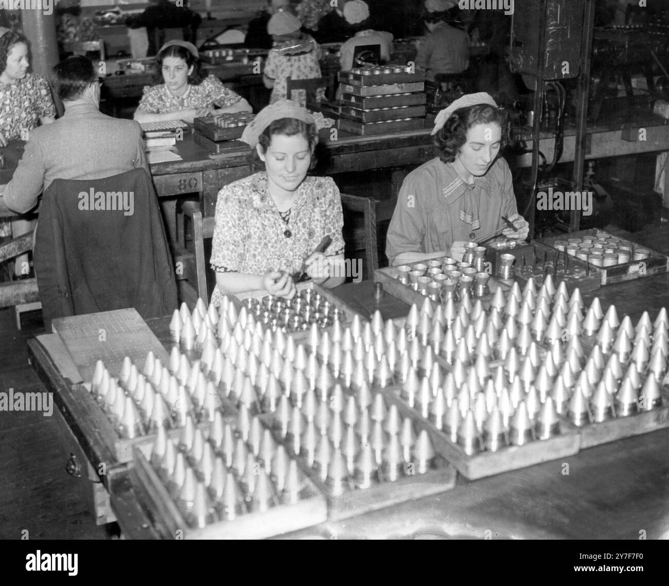 Girls working on shell caps in a munitions factory in Britain, May 1940 ...