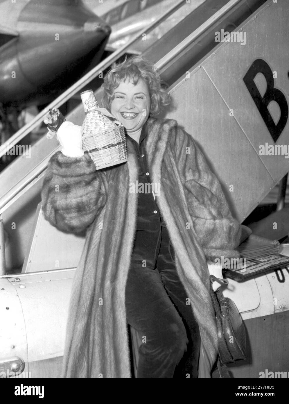 Arriving at London airport in holiday mood singer Joan Turner with a ...