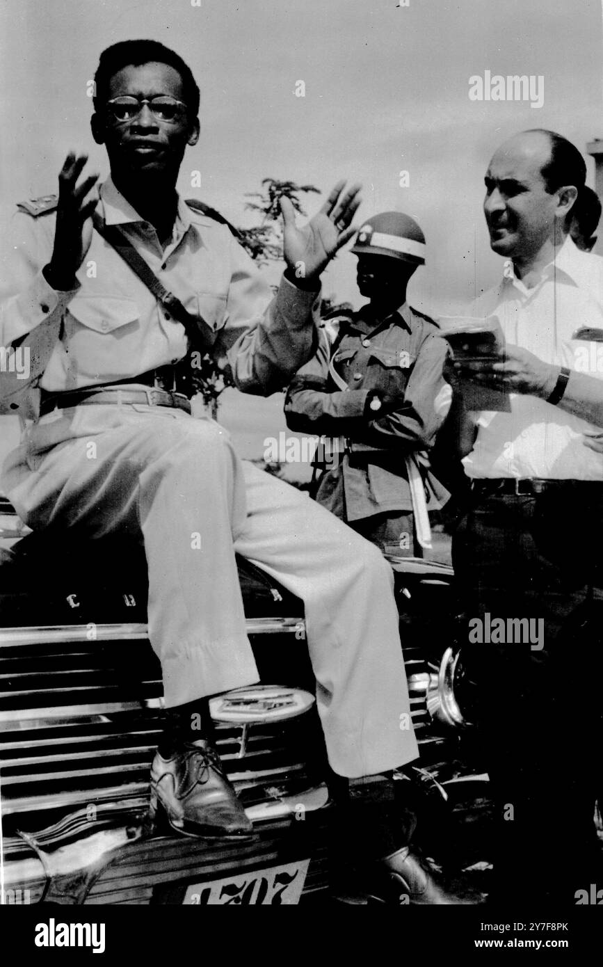 Colonel Joseph Mobutu Congo "Strong Man" sits nonchantly on a car as he ...
