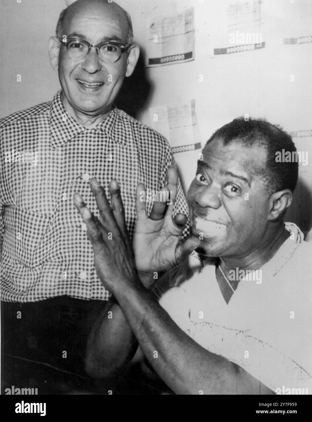 Louis Armstrong plays an imaginary trumpet from his bed in the Spoleto ...