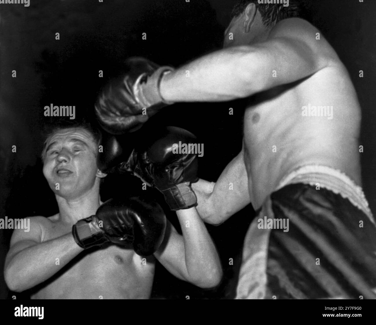 Wembley, Middlesex: Terry Spinks of London, gets his face twisted from ...