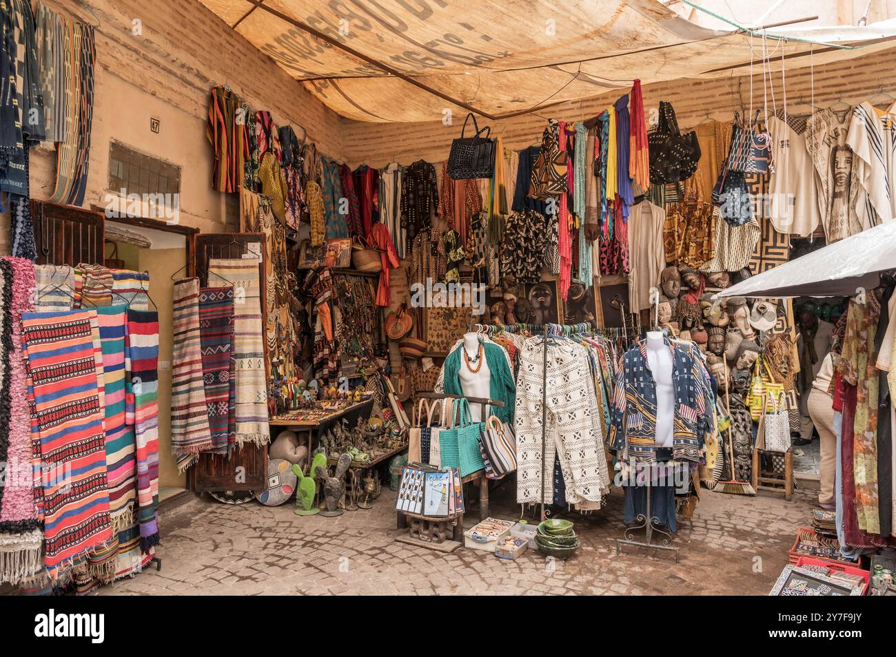 Clothing shop at a traditional Moroccan market, souk, in Marrakech ...