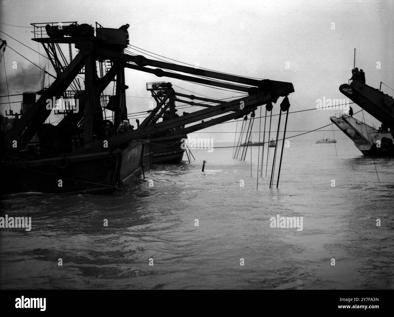 The inch by inch raising of the 1,000 tons deadweight of the submarine ...