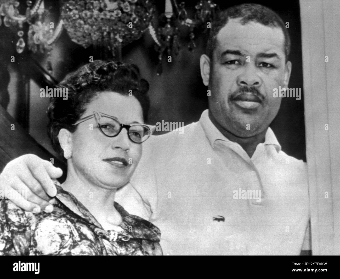 Joe Louis puts his arm around the shoulders of his bride Mrs Martha ...