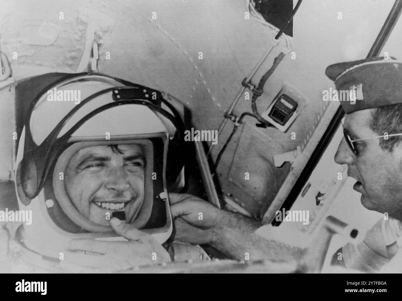 Capt Ralph Richardson adjusts the helmet of Major Robert White, US Air ...