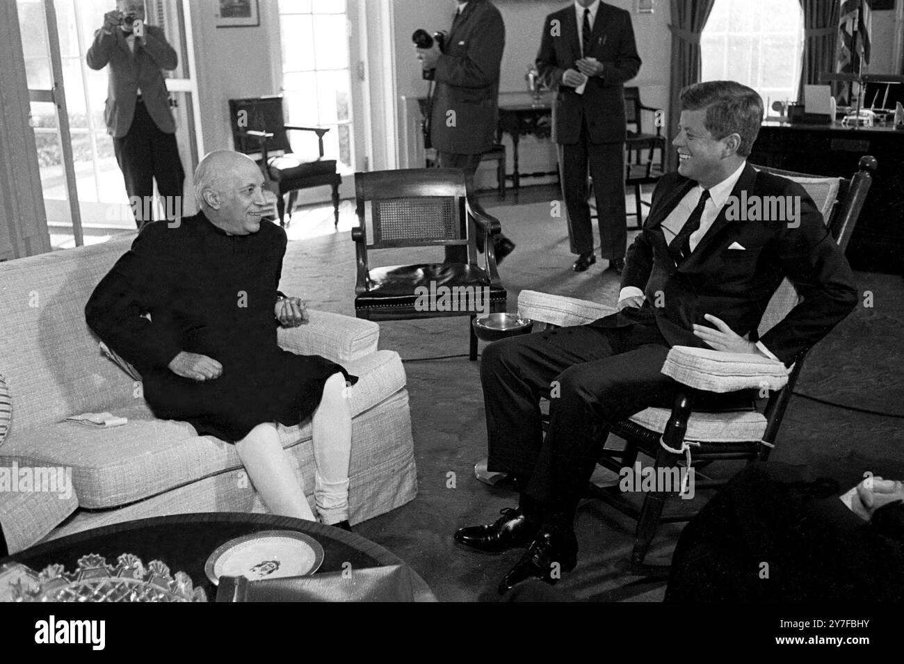 President John F Kennedy seated in his rocking chair with Prime ...