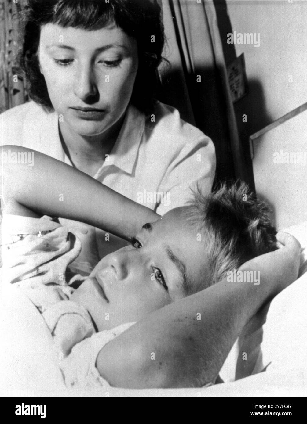 Nurse Eleanor Weaver comforts eight year old Roger Woodward in the ...